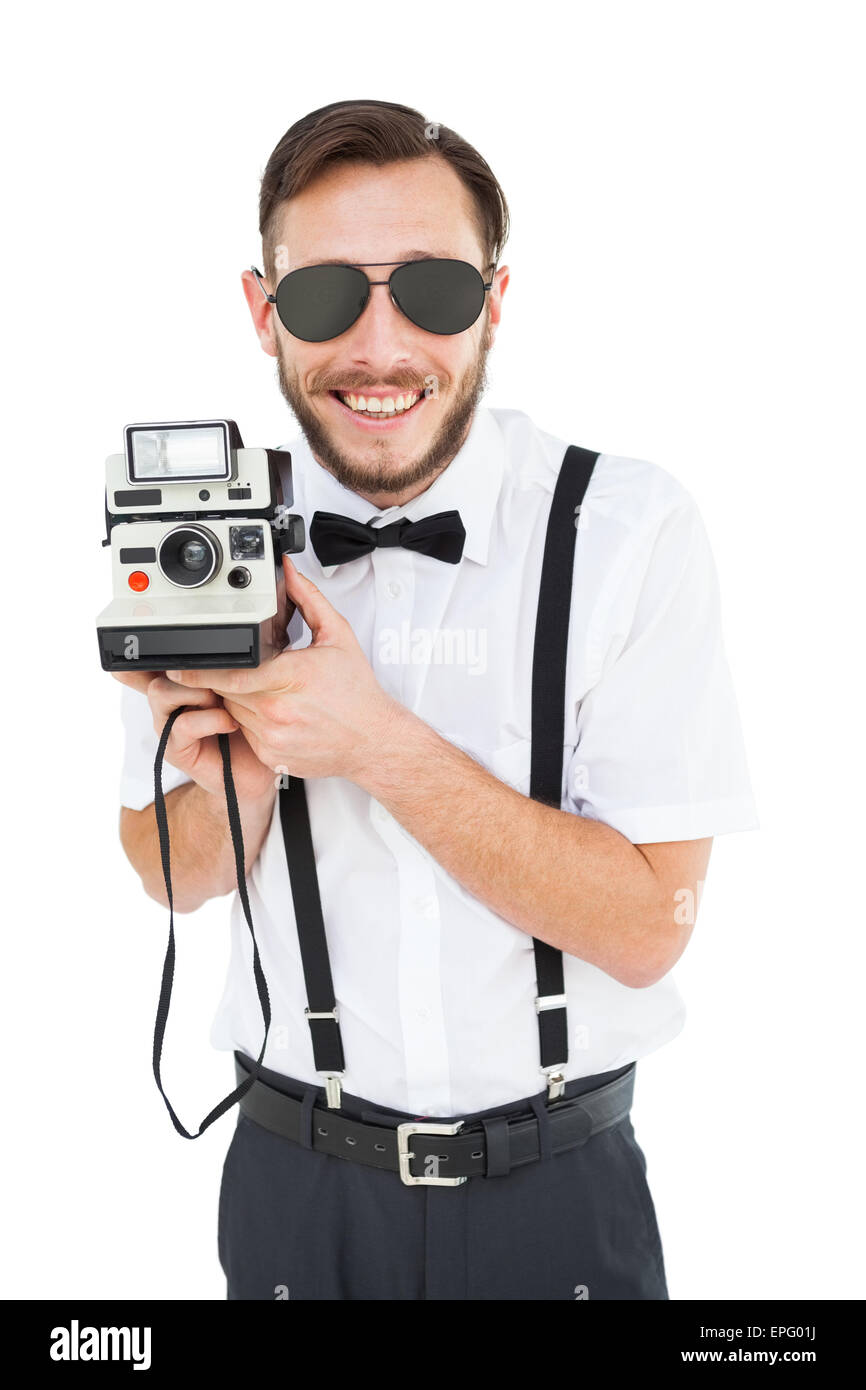 Geeky hipster holding a retro camera Stock Photo - Alamy