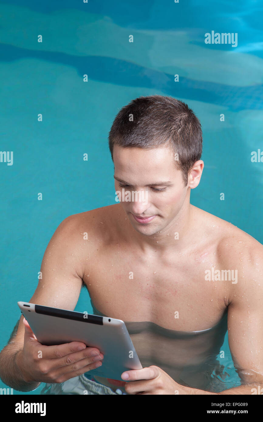 Man in the edge of the pool Stock Photo - Alamy