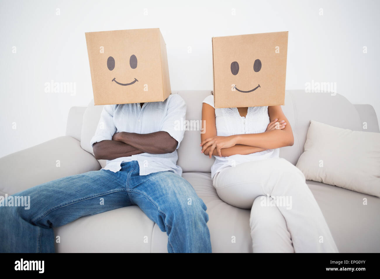 Couple sitting on couch together with boxes over head Stock Photo - Alamy