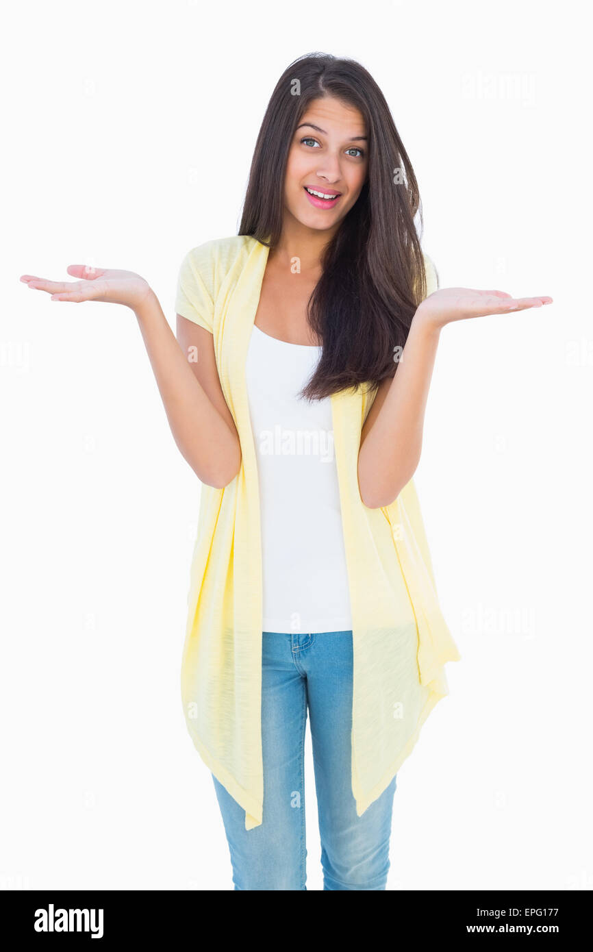 Happy casual woman shrugging her shoulders Stock Photo - Alamy