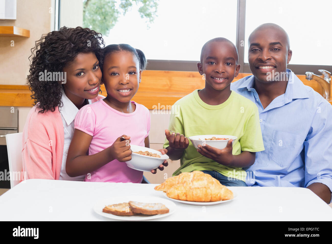 Happy family having breakfast together in the morning Stock Photo - Alamy