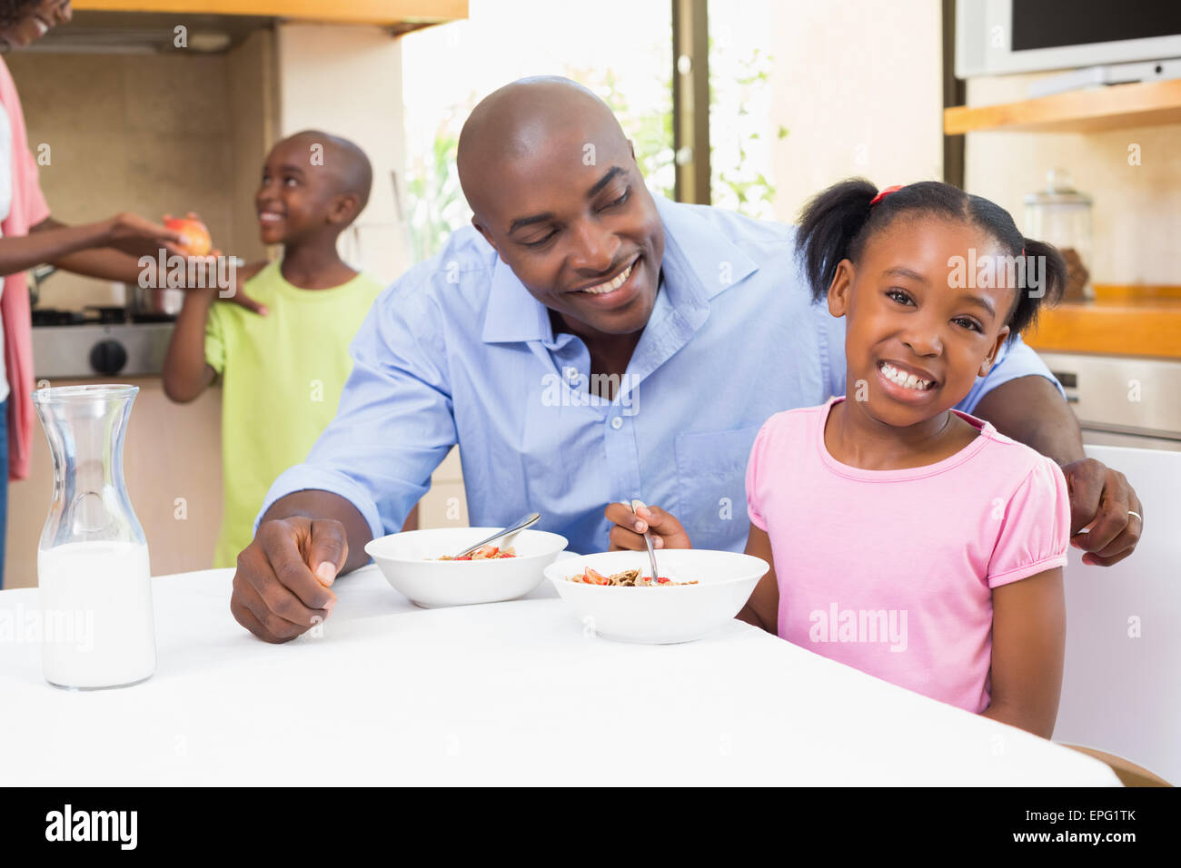 Happy family having breakfast together in the morning Stock Photo - Alamy