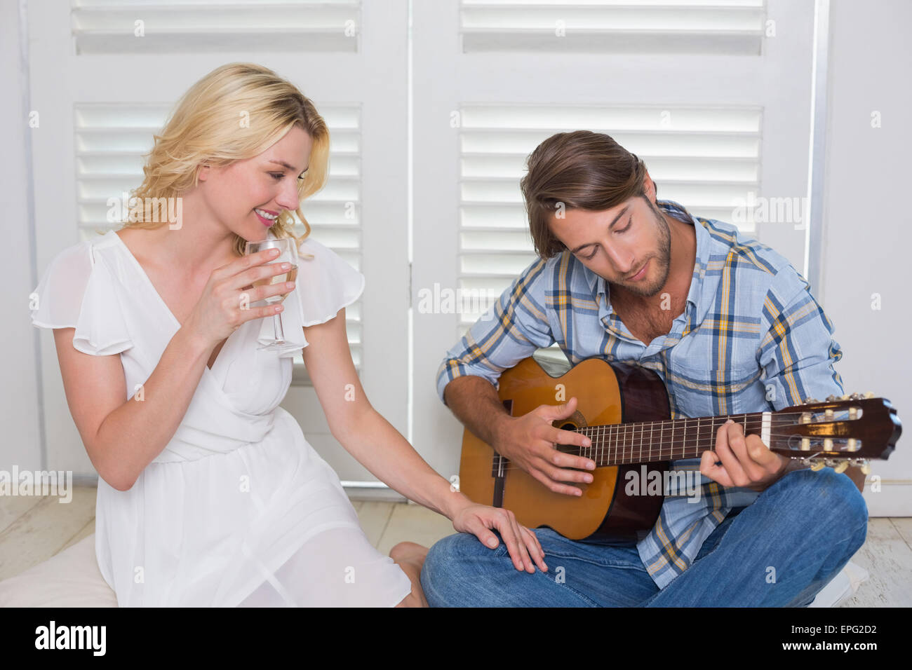 Handsome man serenading his girlfriend with guitar Stock Photo - Alamy