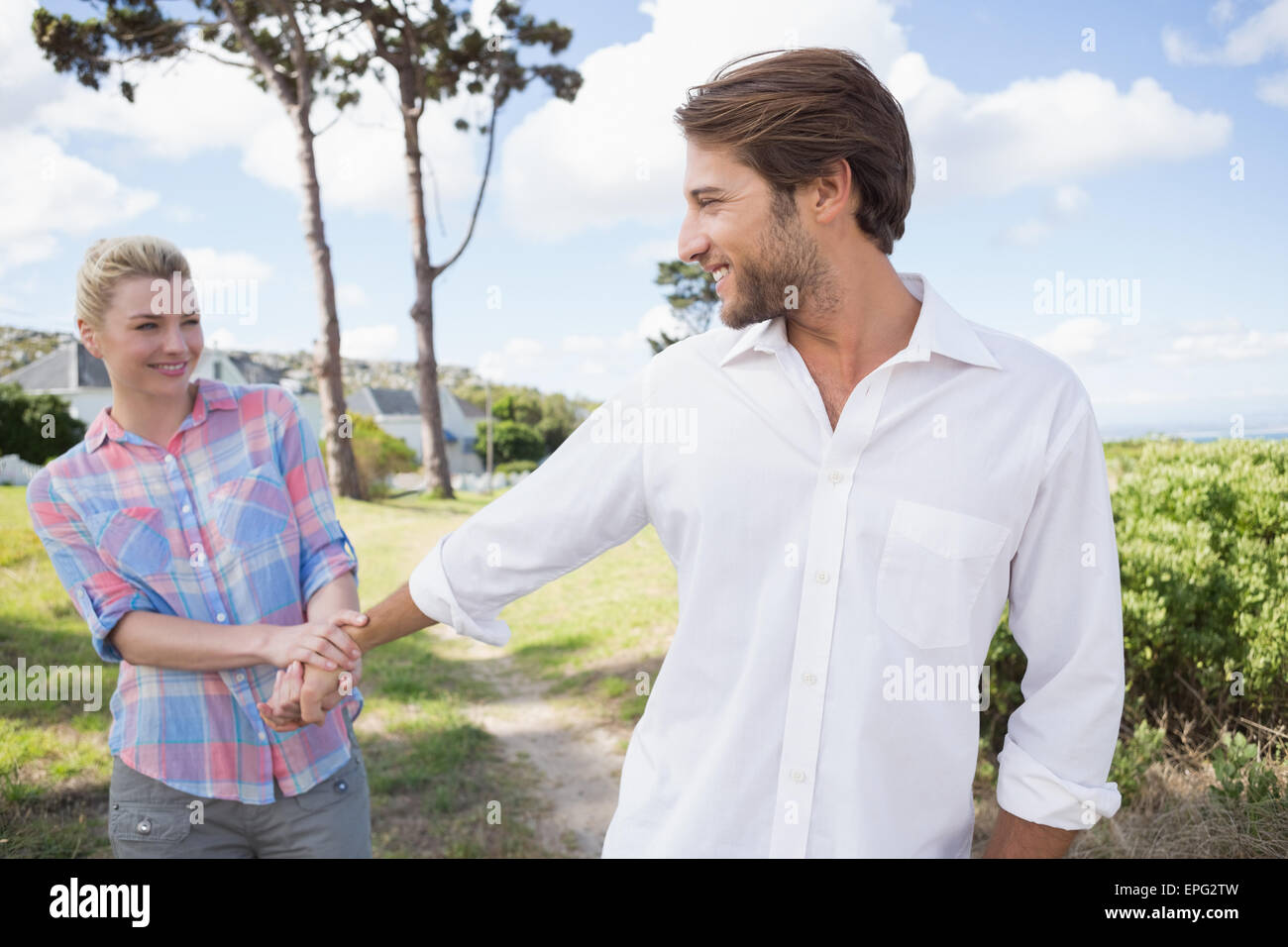 Smiling couple standing outside together in their garden Stock Photo ...