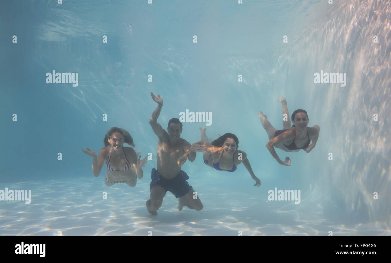 Friends swimming underwater together hi-res stock photography and ...