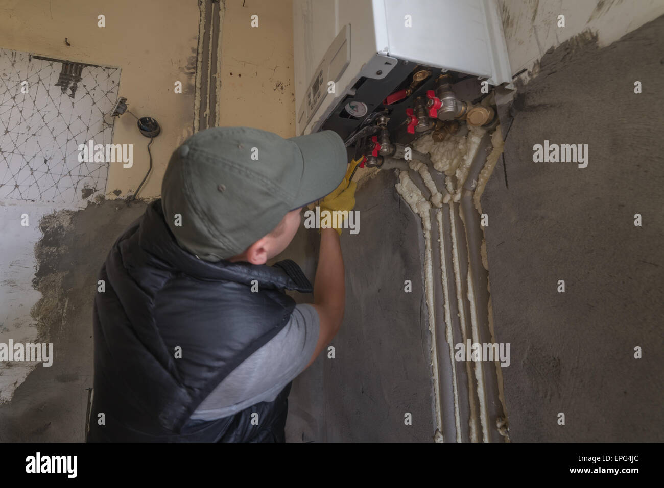 pipefitter installing system of heating Stock Photo - Alamy