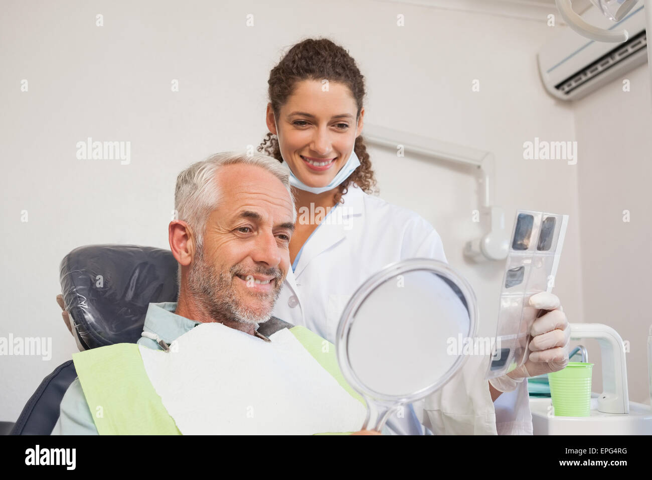 Patient admiring his new smile in the mirror Stock Photo - Alamy
