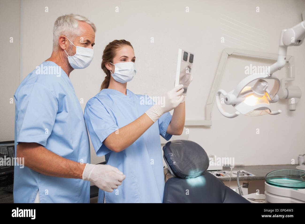 Dentist and assistant studying x-rays Stock Photo - Alamy