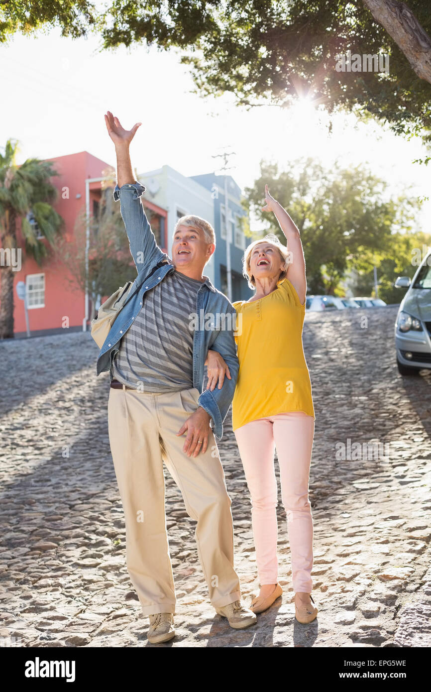 Happy mature couple cheering in the city Stock Photo - Alamy