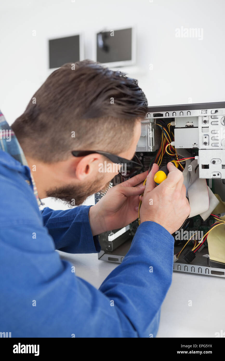 Computer engineer working on broken console with screwdriver Stock ...