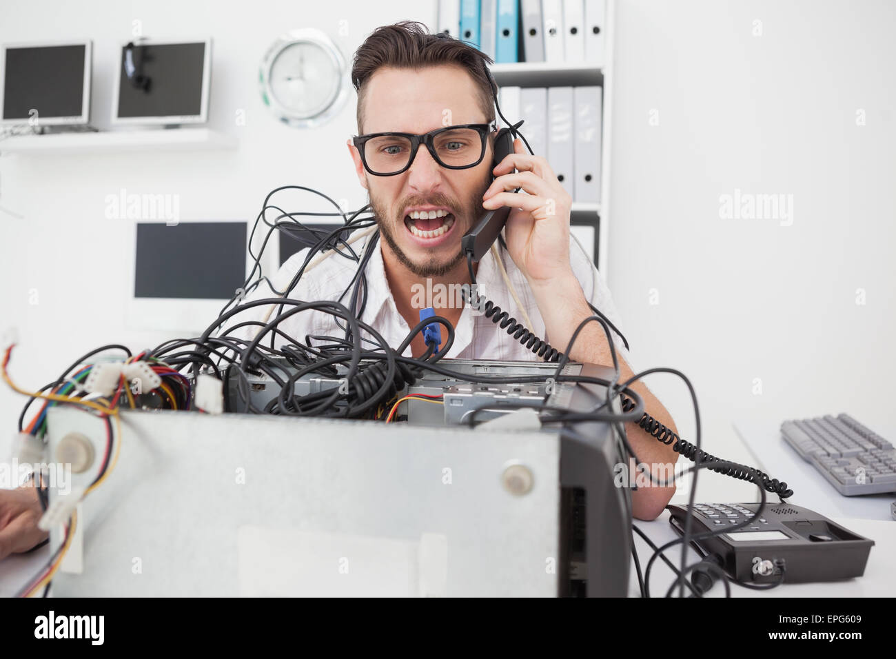 Angry computer engineer making a call Stock Photo - Alamy