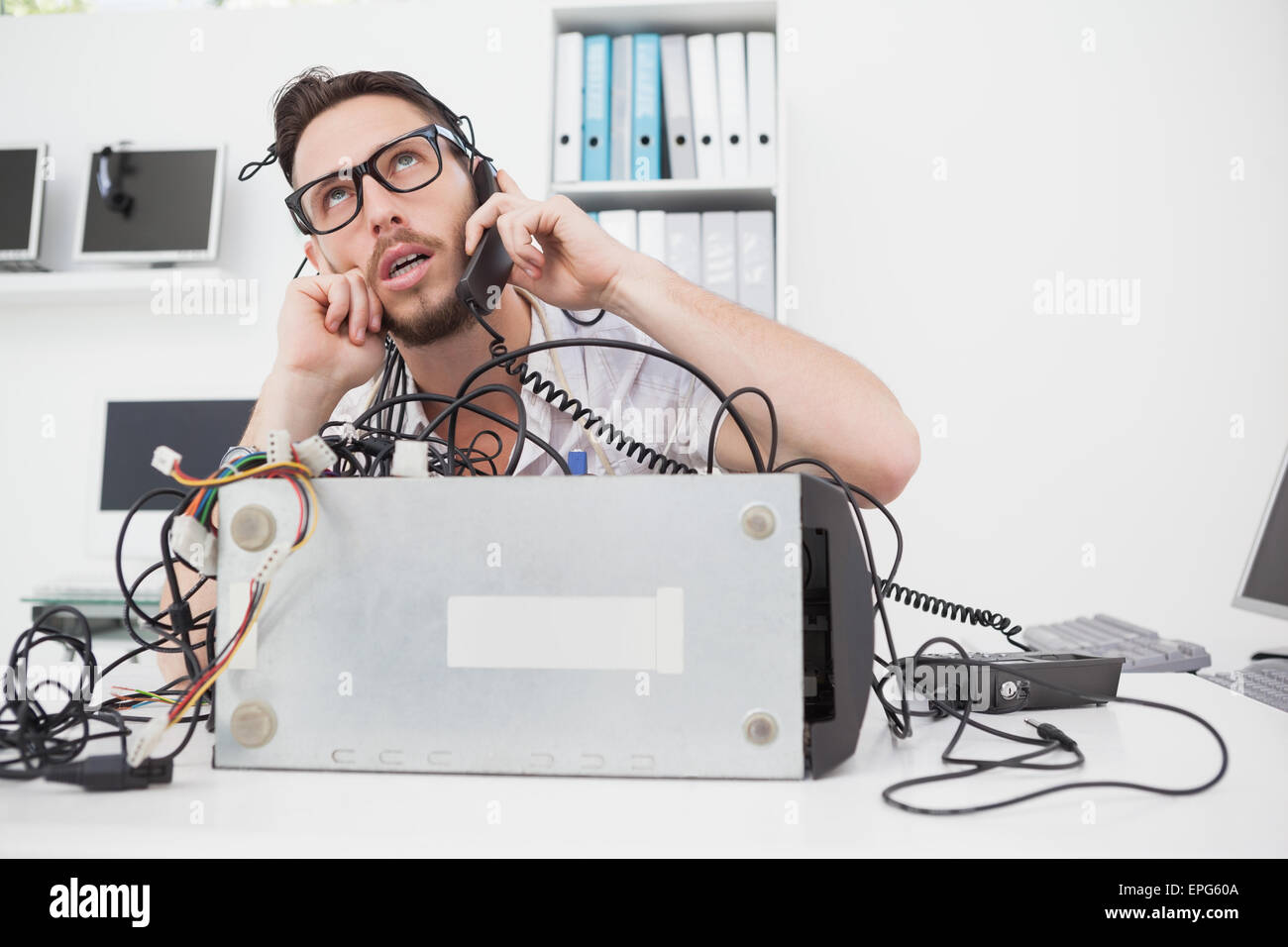 Annoyed computer engineer making a call Stock Photo - Alamy