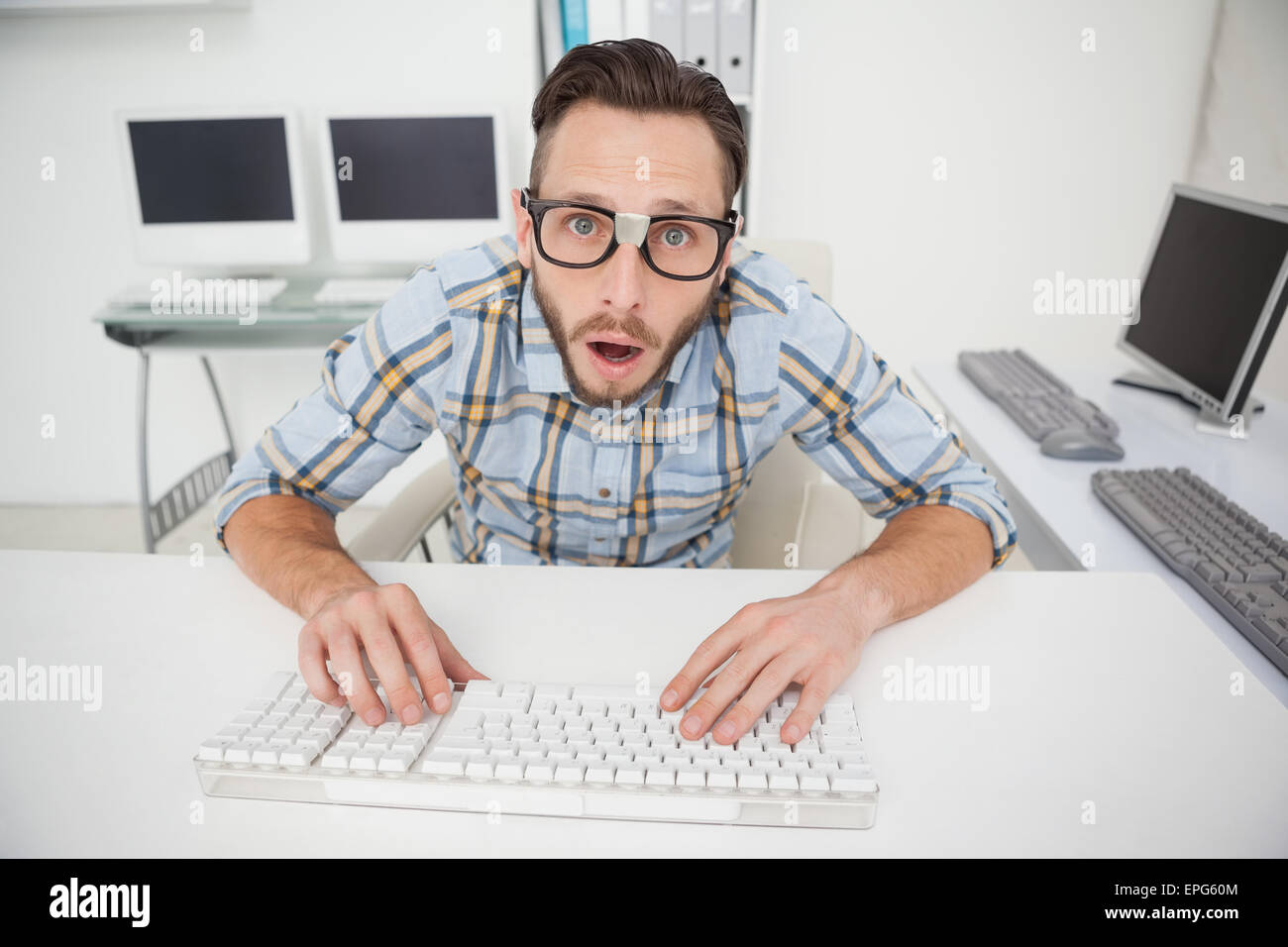 Puzzled nerdy businessman working on computer Stock Photo - Alamy
