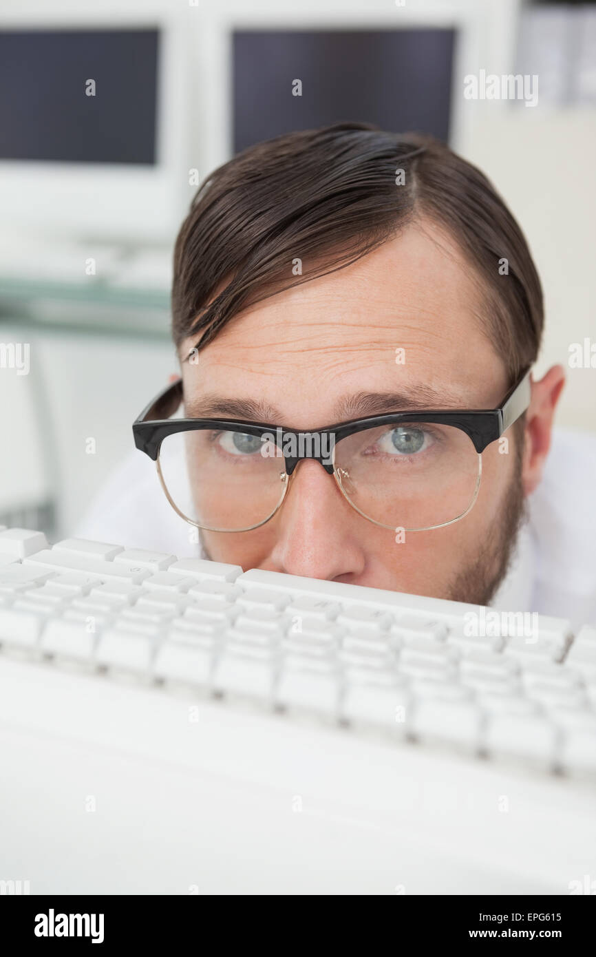 Nerdy businessman hiding behind keyboard Stock Photo - Alamy Nerdy businessman hiding behind keyboard Stock Photo - Alamy