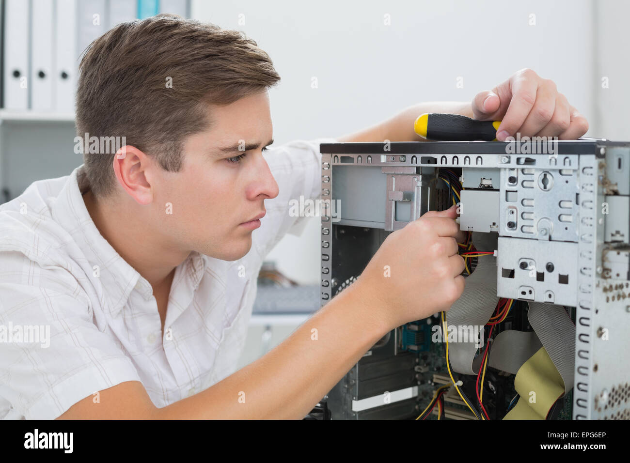 Young technician working on broken computer Stock Photo - Alamy