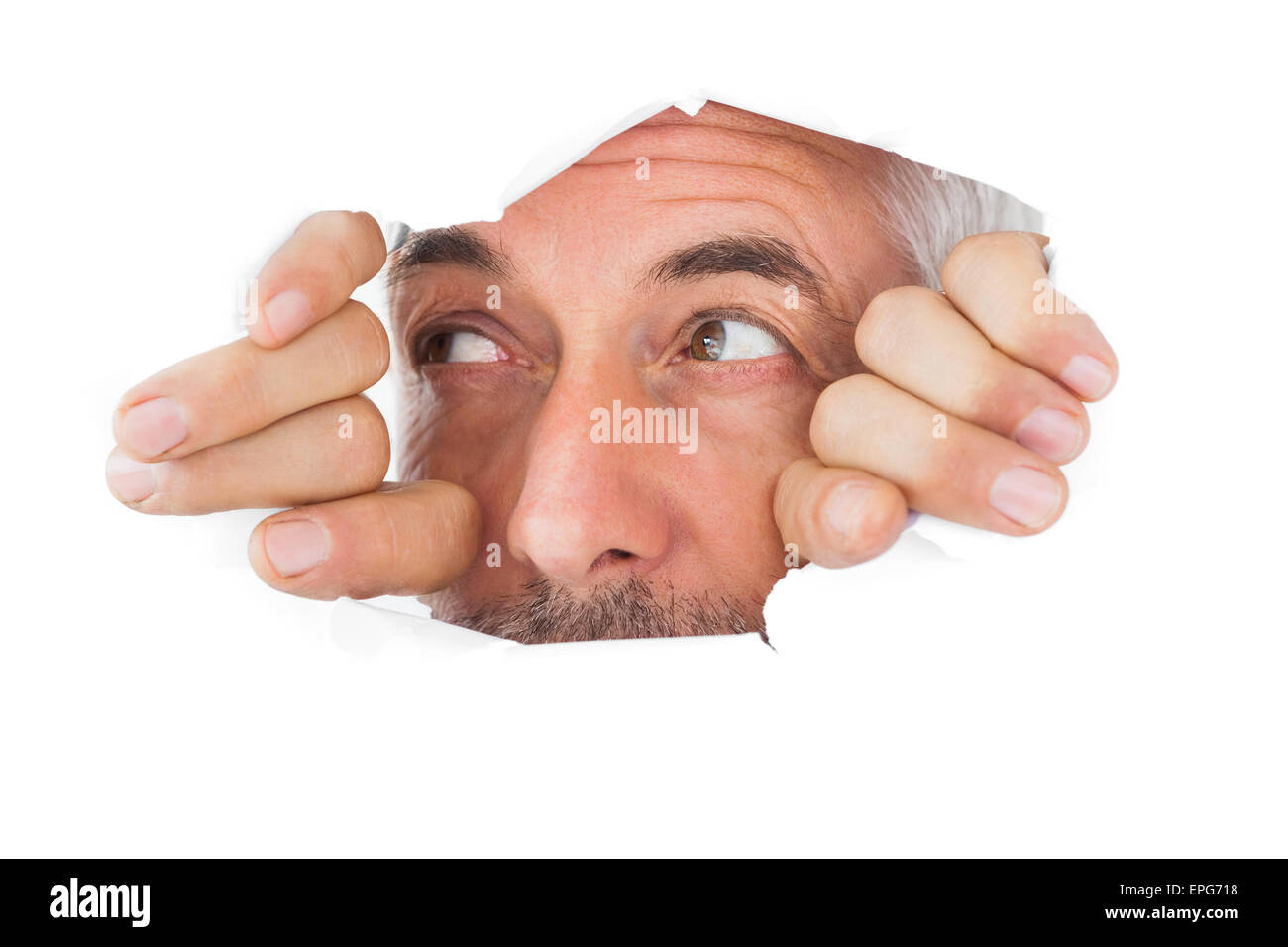 Man looking through torn paper Stock Photo - Alamy