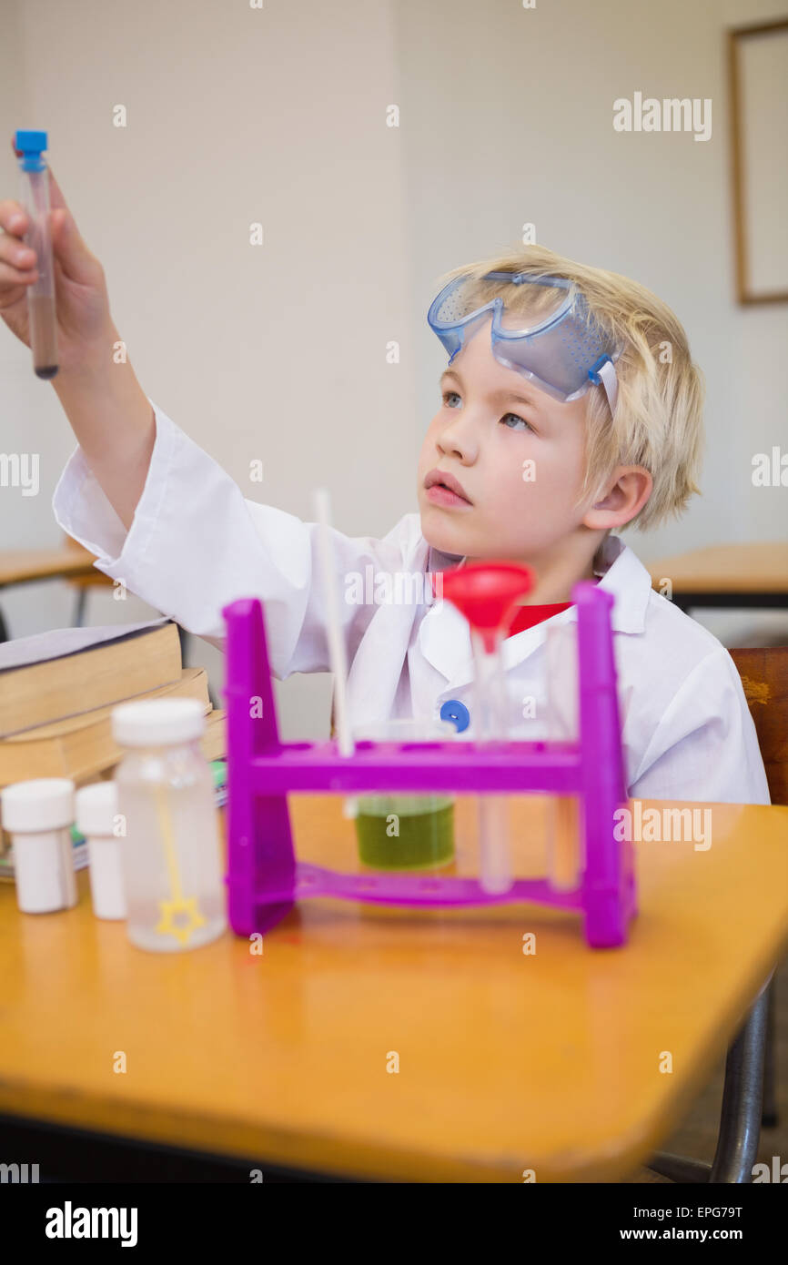 Cute pupil dressed up as scientist in classroom Stock Photo - Alamy