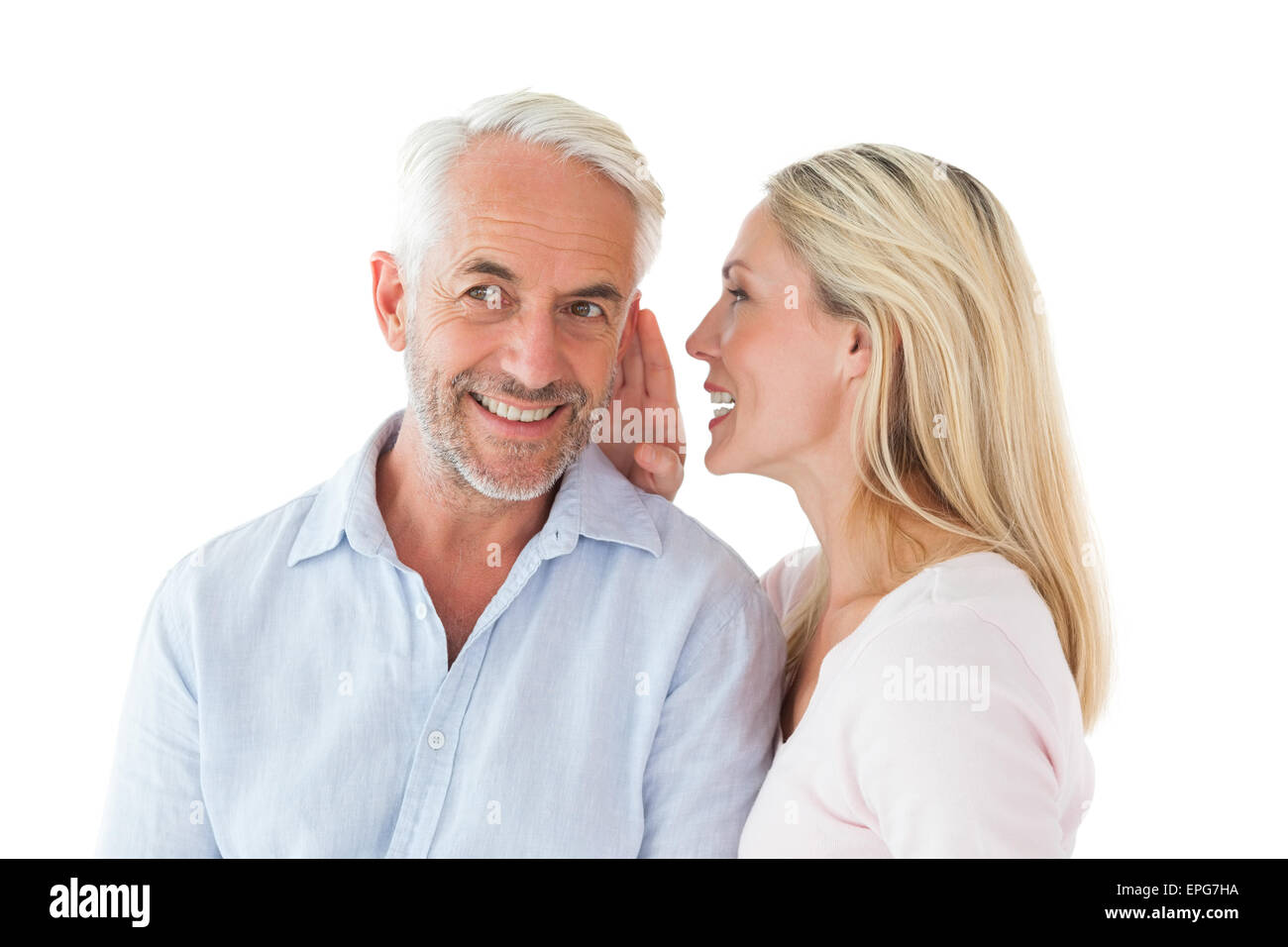 Woman whispering a secret to husband Stock Photo - Alamy