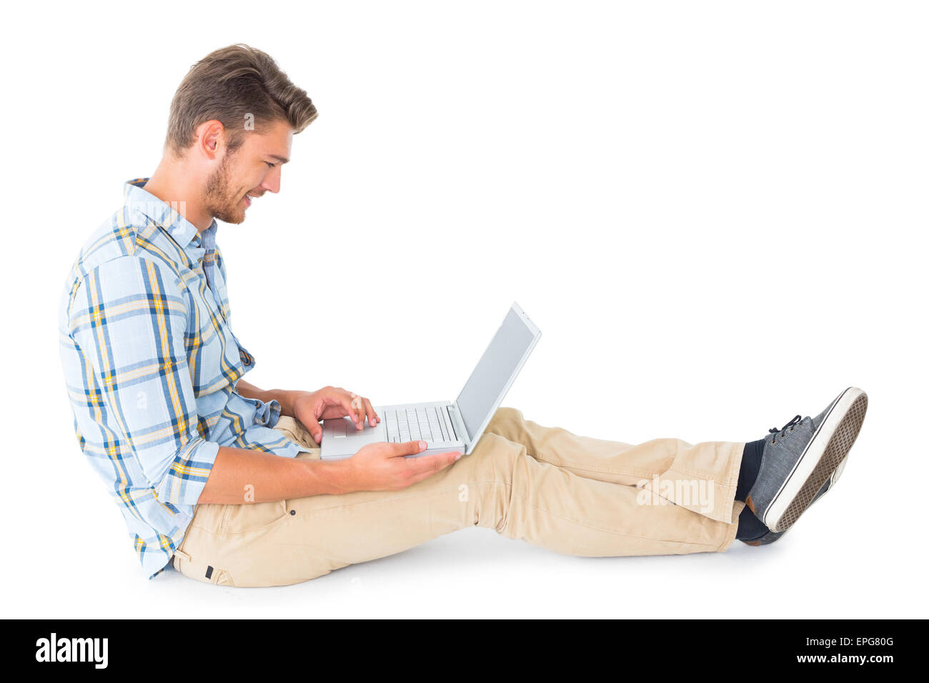 Handsome young man sitting using laptop Stock Photo - Alamy