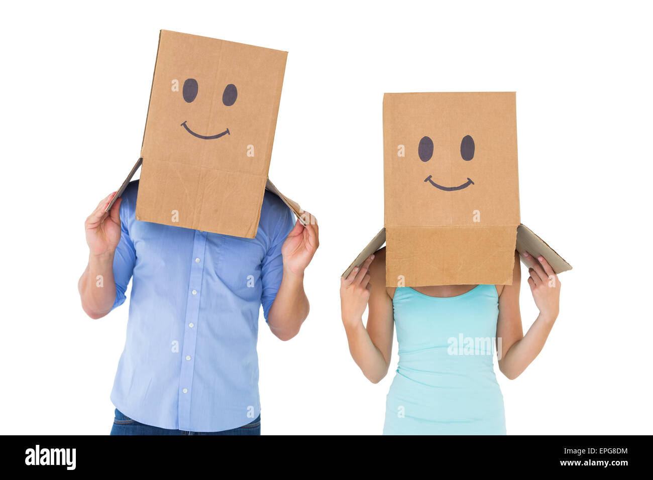 Couple wearing emoticon face boxes on their heads Stock Photo - Alamy