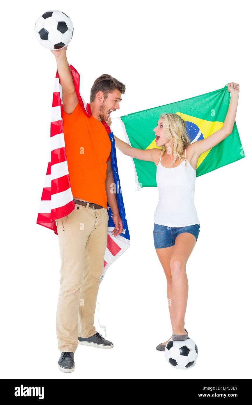 Excited football fan couple holding usa and brazils flag Stock Photo ...
