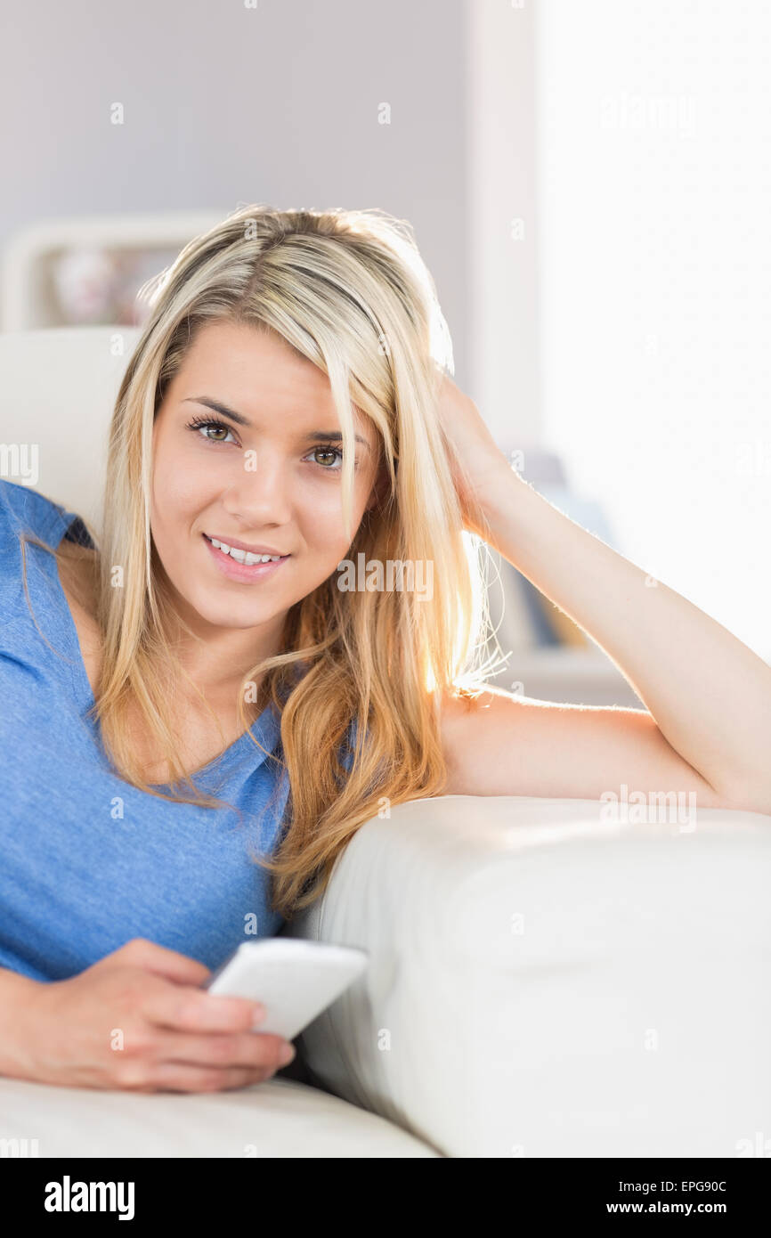 Beautiful woman text messaging in living room Stock Photo - Alamy