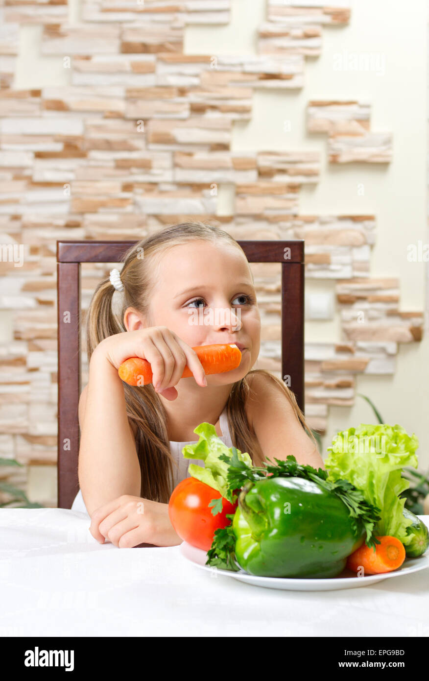 Little girl eat vegetables at room Stock Photo - Alamy