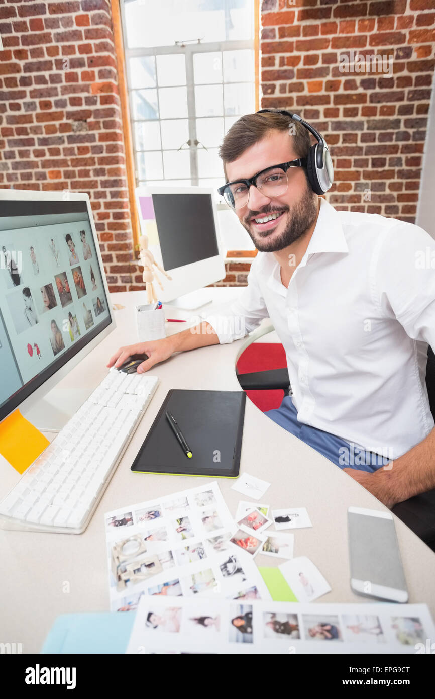 Smiling photo editor using computer in office Stock Photo - Alamy