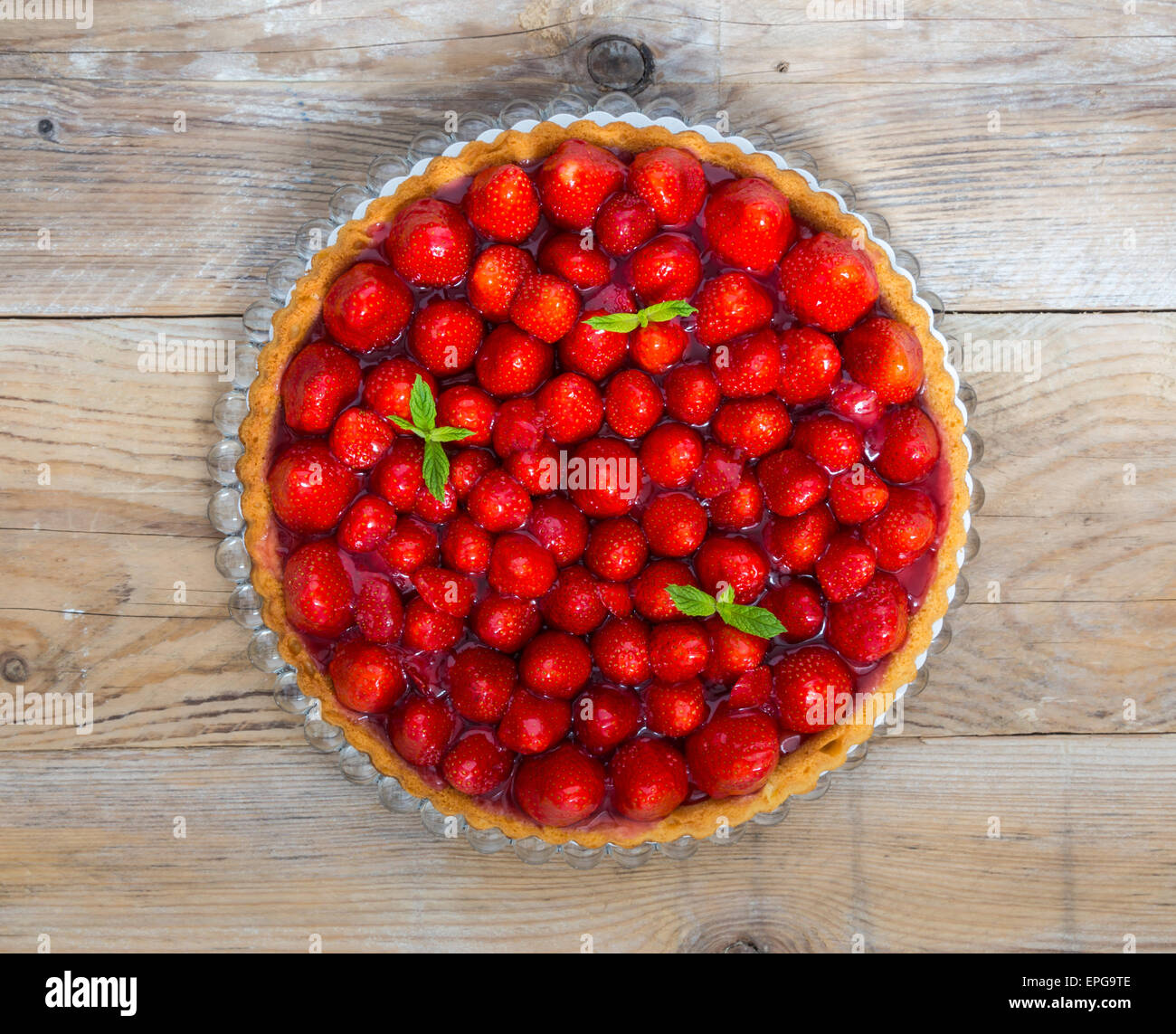 Strawberry cake with mint leaves on a rustic wood Stock Photo - Alamy