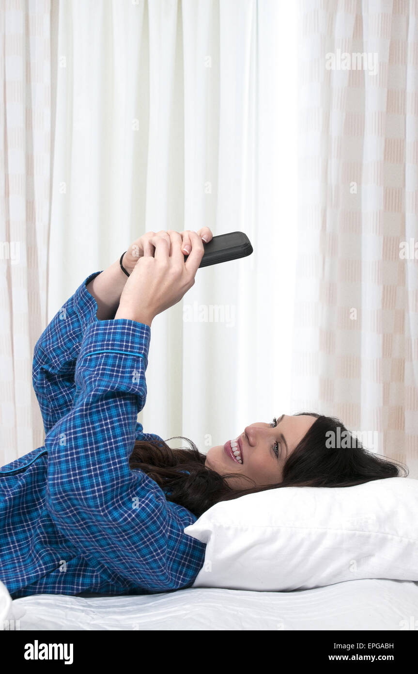 Woman Texting in Bed Stock Photo - Alamy