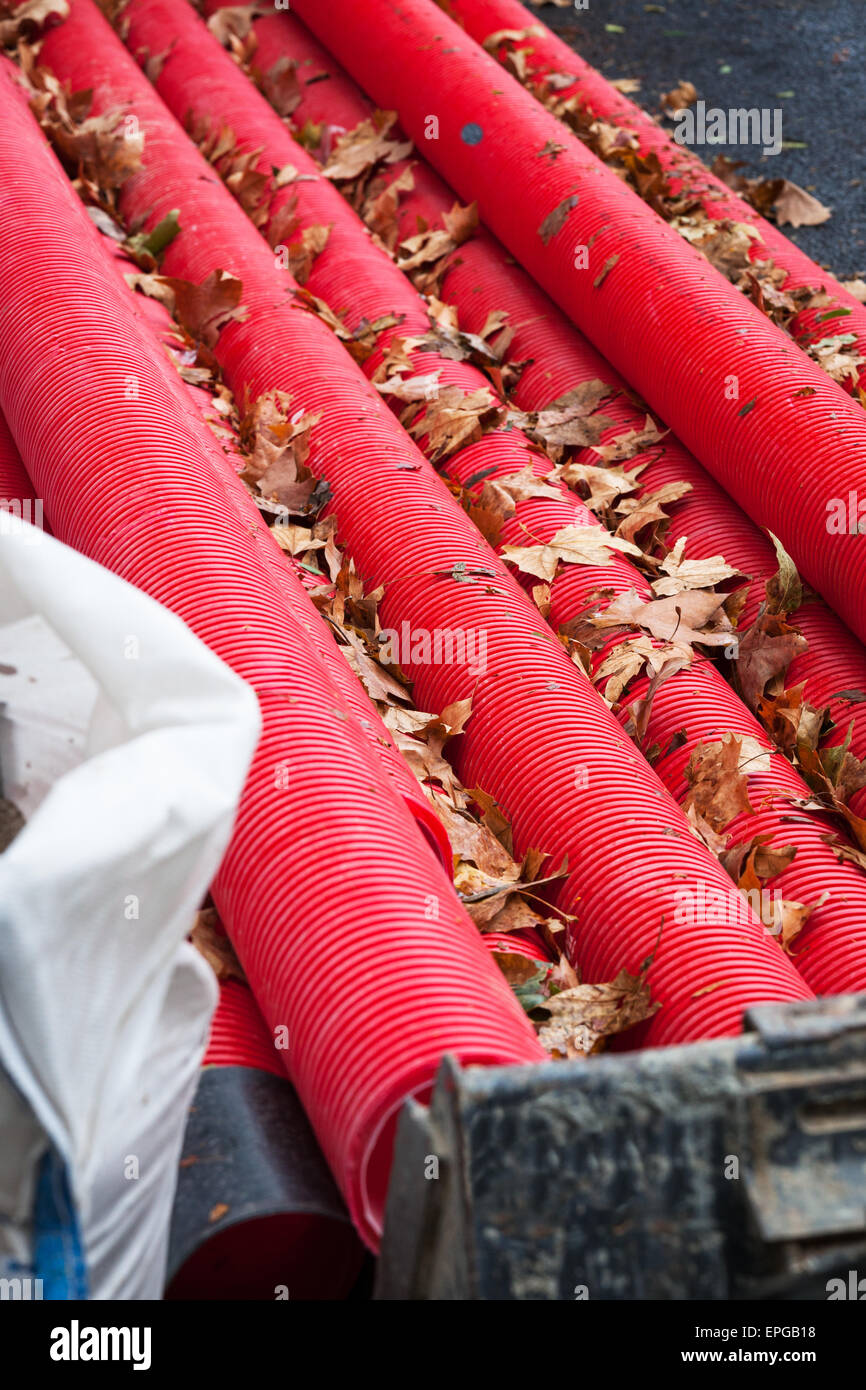 laying red water pipe Stock Photo - Alamy