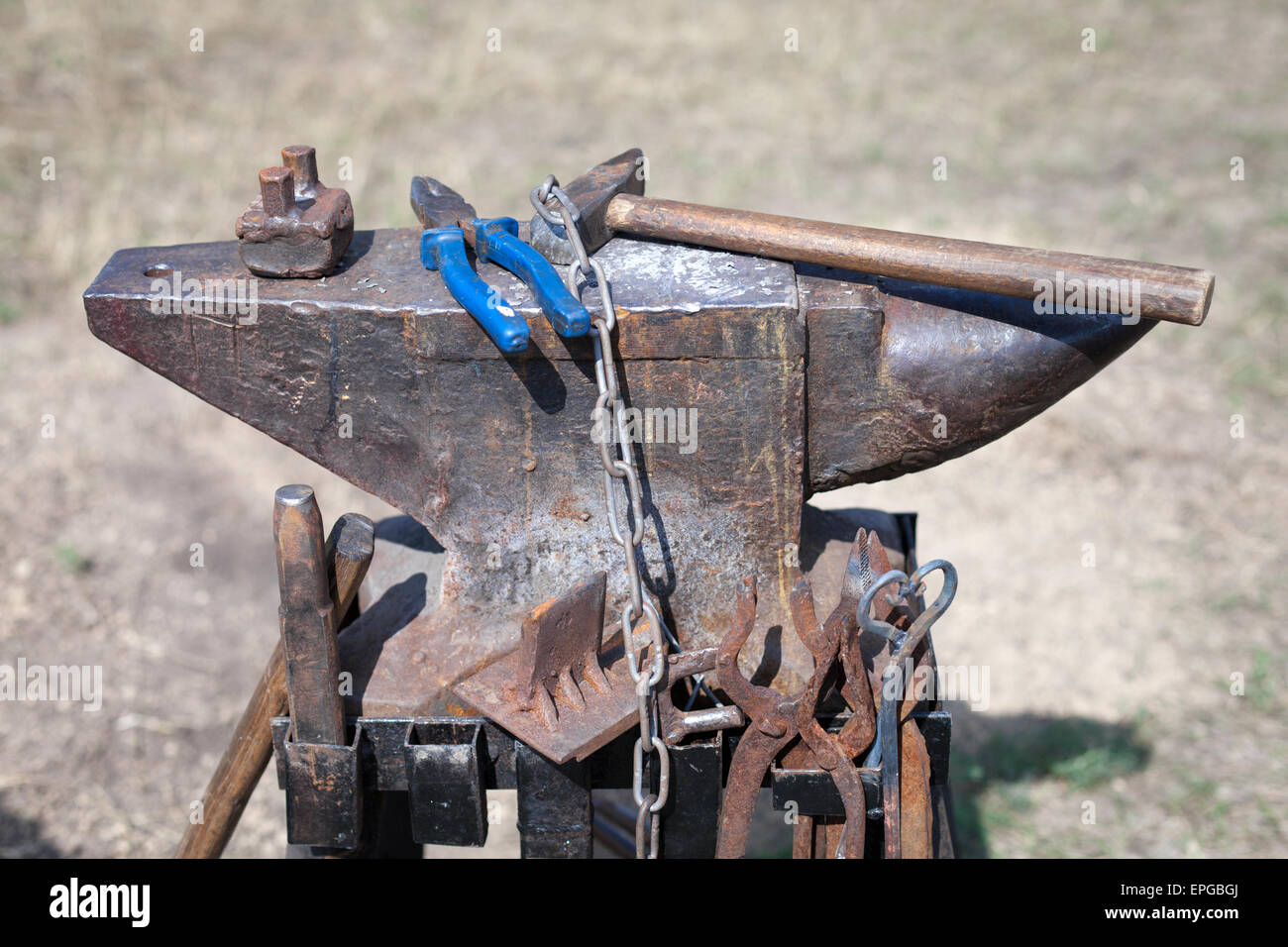 old anvil with many blacksmith tools Stock Photo - Alamy