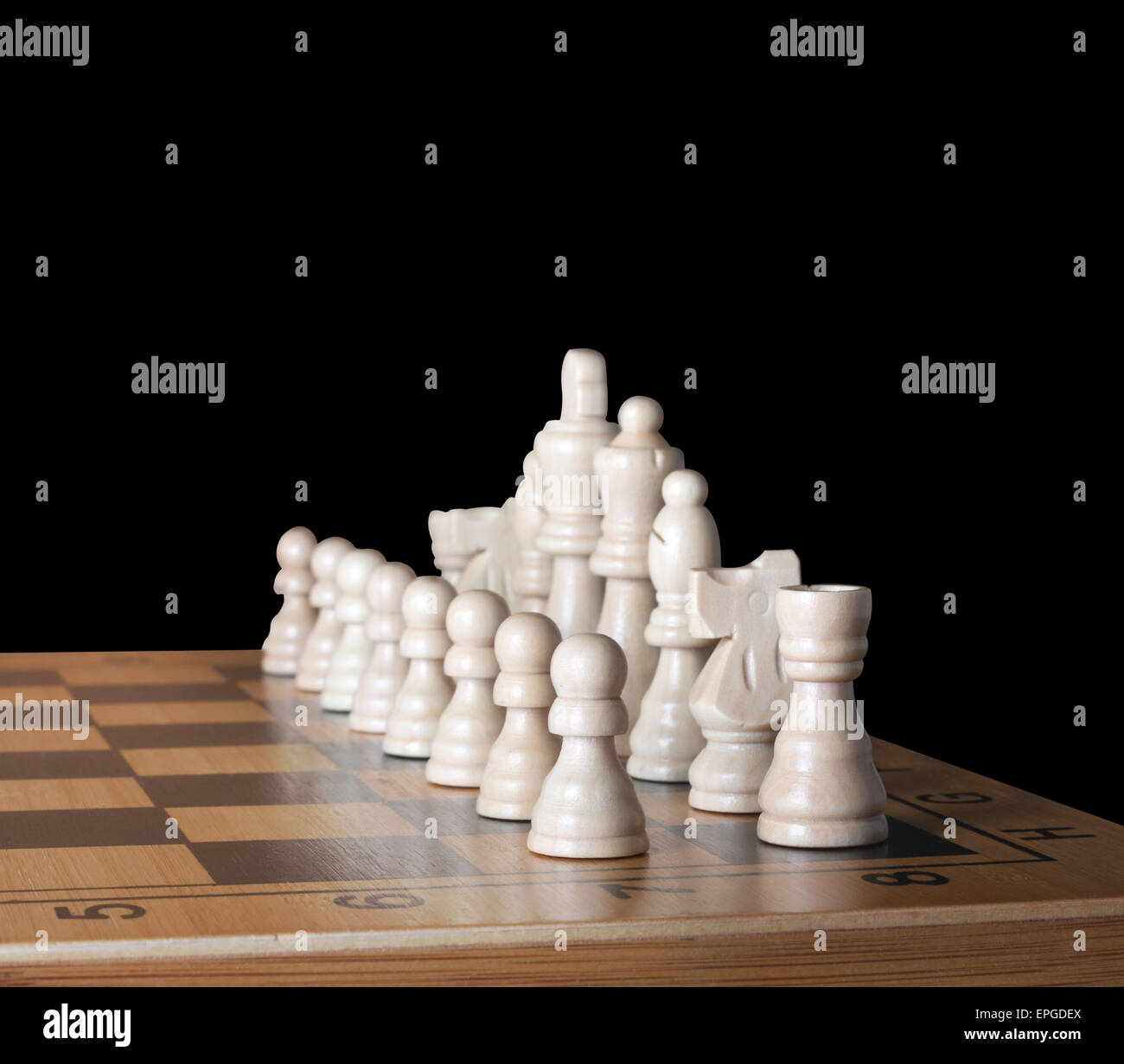 Wooden chess board with figures on table and old wall Stock Photo - Alamy