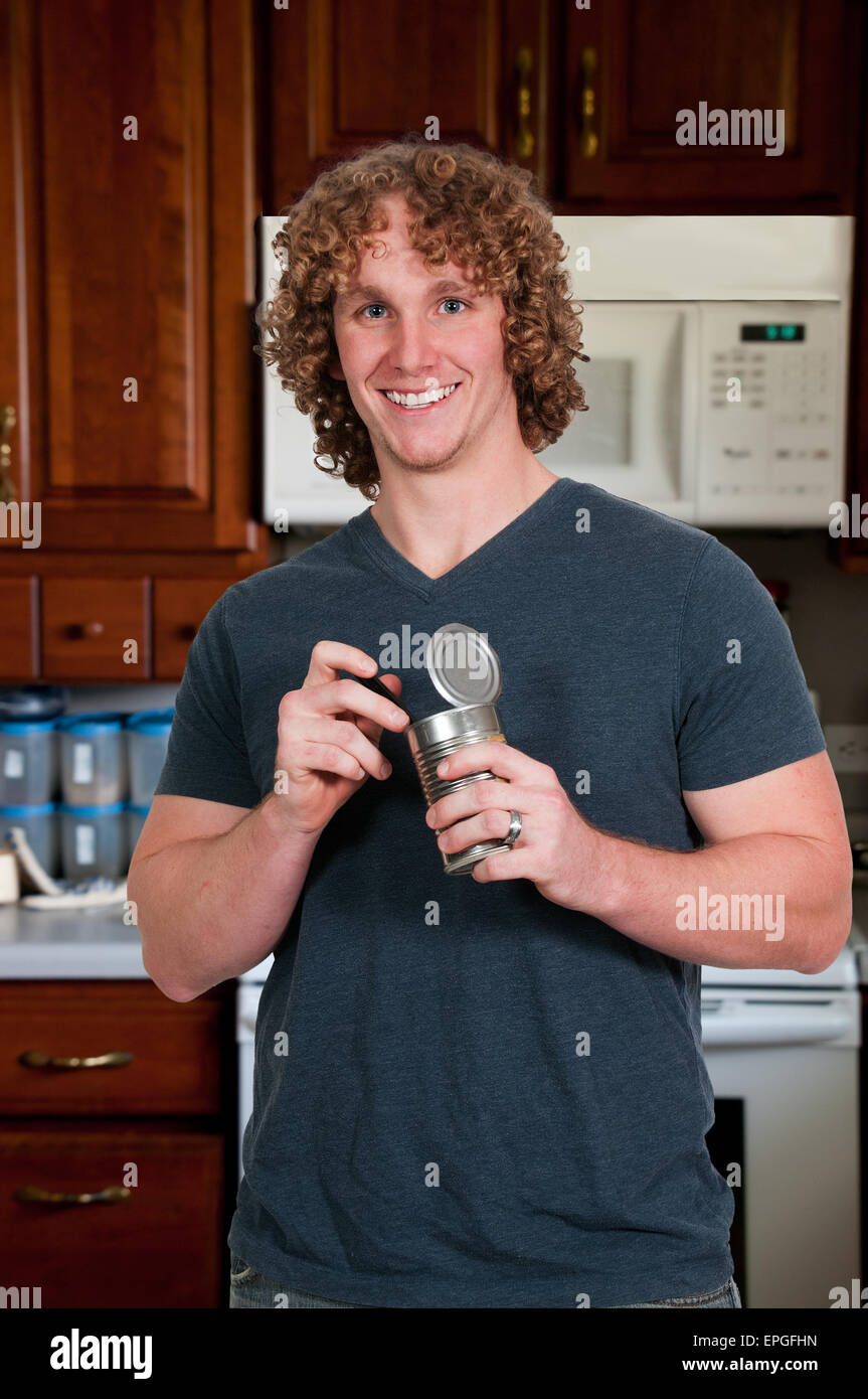 Man eating canned food Stock Photo - Alamy