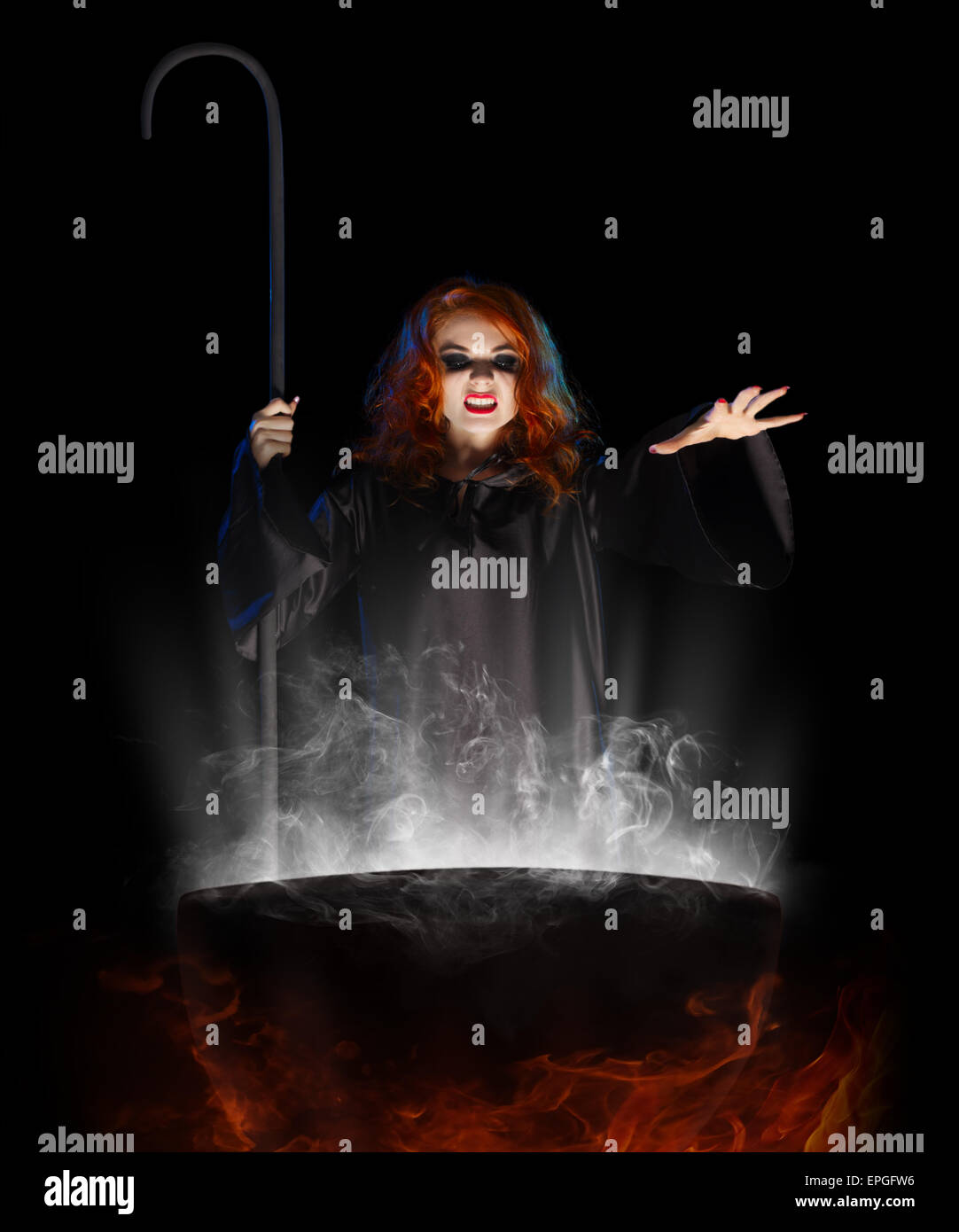 Young witch with cauldron isolated Stock Photo - Alamy