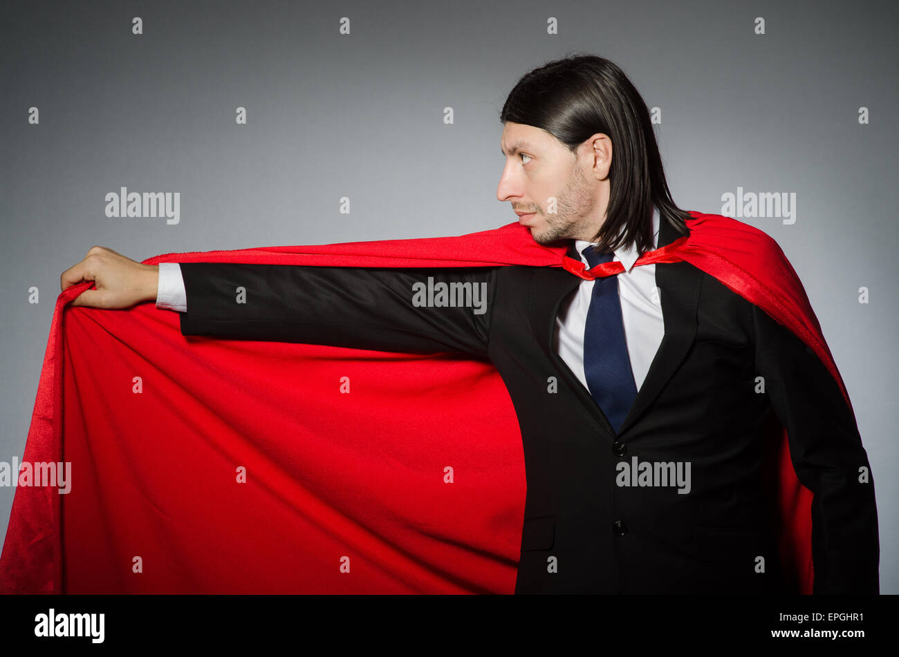 Superman concept with man in red cover Stock Photo - Alamy