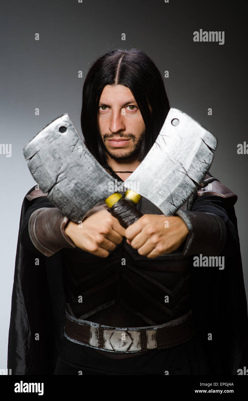 Knight with axe against dark background Stock Photo - Alamy