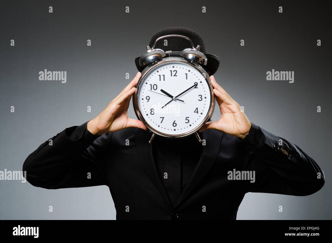 Man with clock wearing vintage hat Stock Photo - Alamy