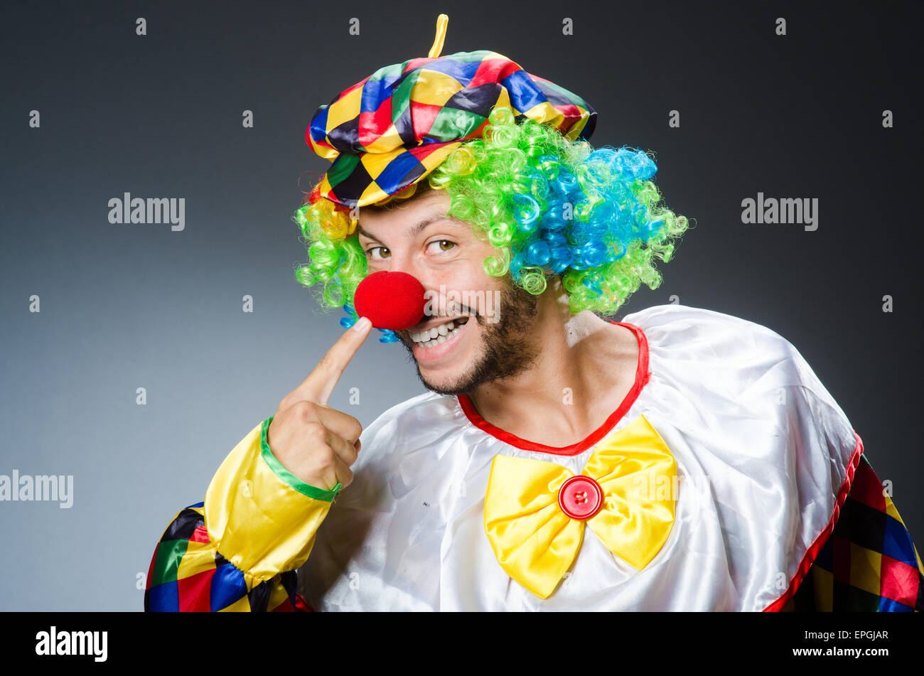 Funny clown in colourful costume Stock Photo - Alamy
