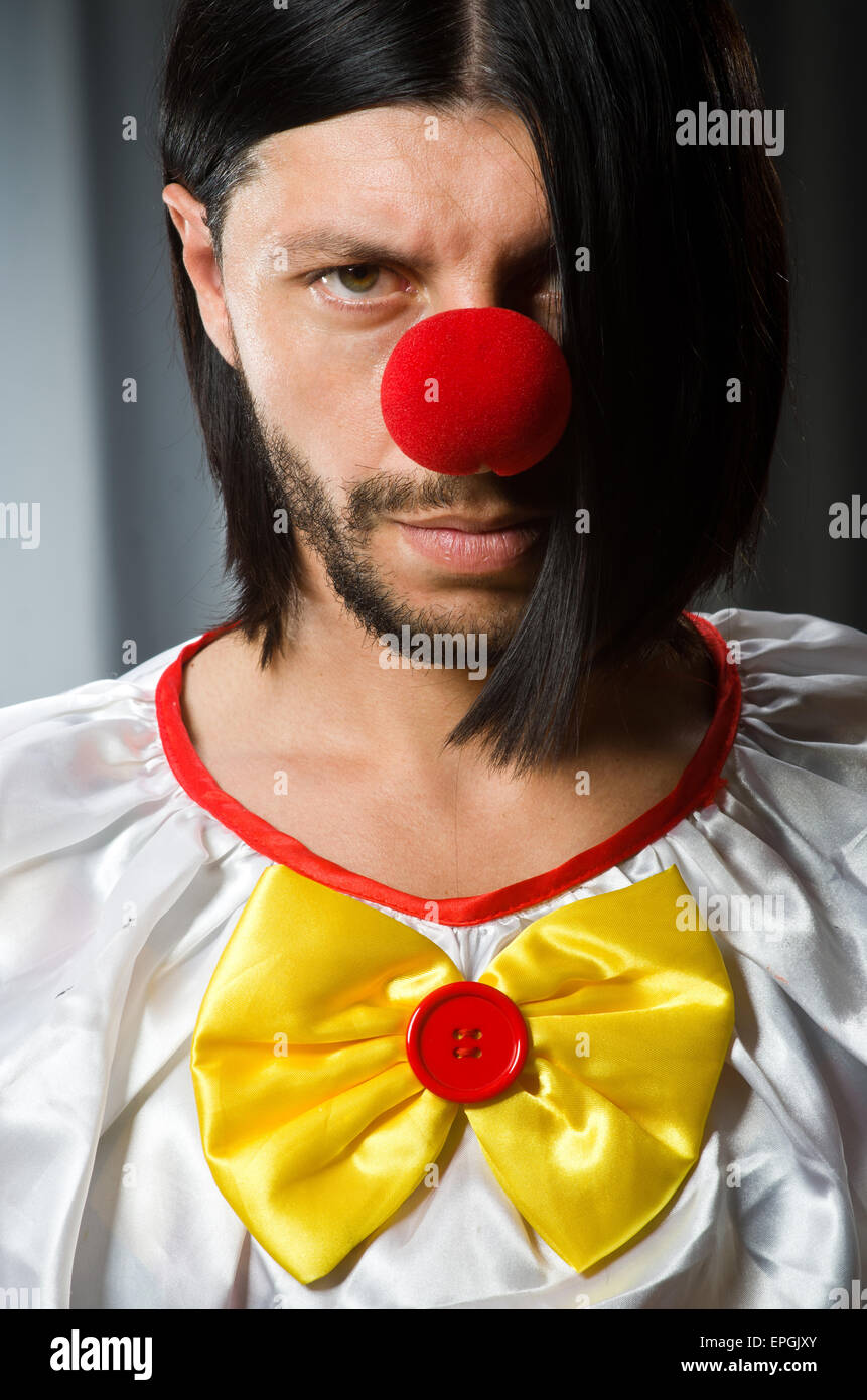 Sad clown against grey background Stock Photo - Alamy