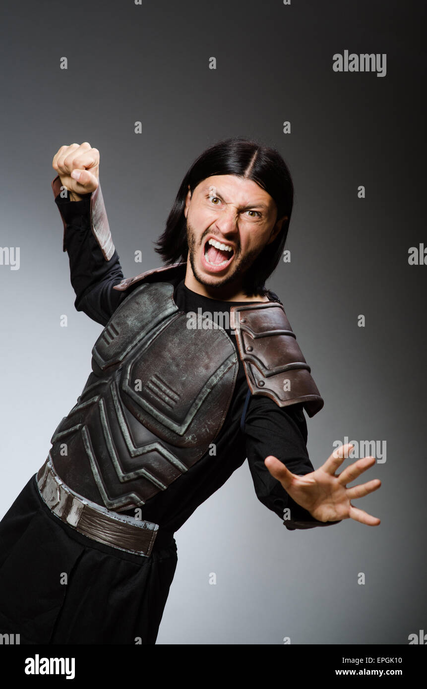 Angry warrior against dark background Stock Photo - Alamy