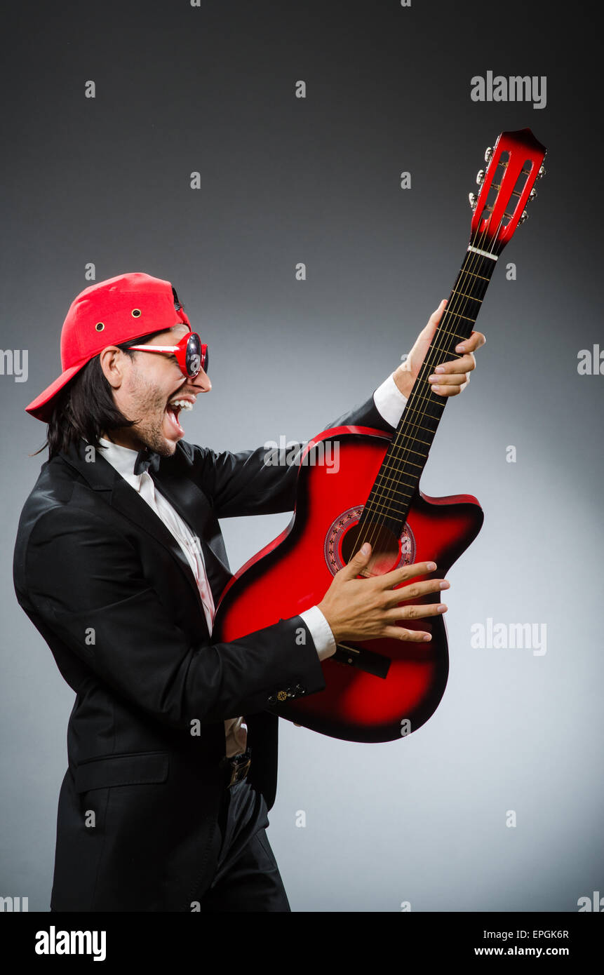 Funny guitar player in studio Stock Photo - Alamy