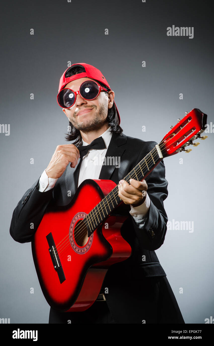 Funny guitar player in studio Stock Photo - Alamy