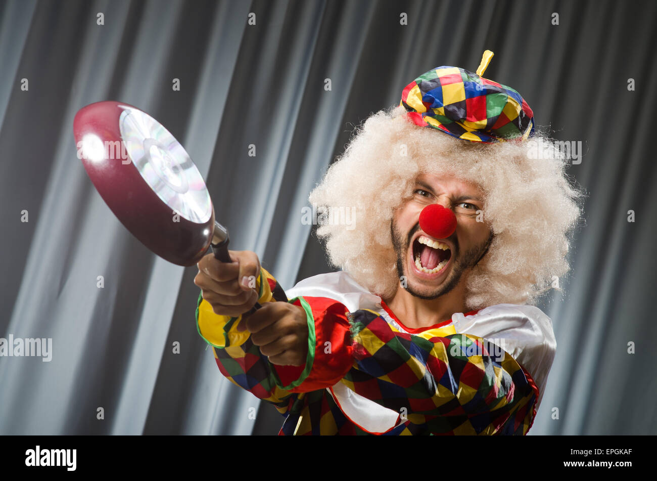 Angry clown with frying pan Stock Photo - Alamy