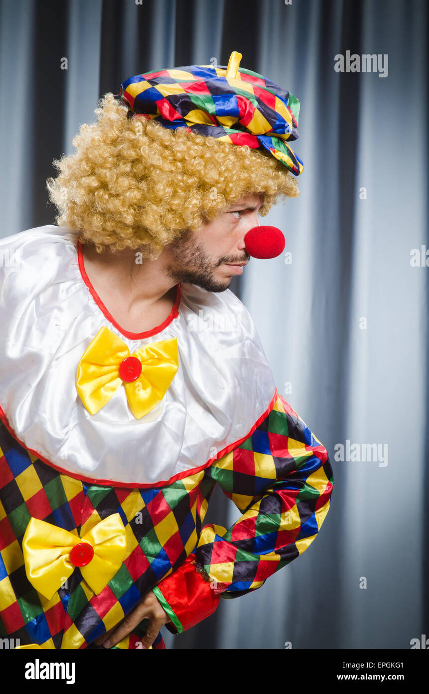 Funny clown in humorous concept against curtain Stock Photo - Alamy