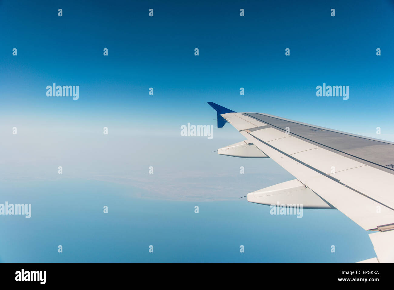 Airplane wing out of window Stock Photo - Alamy