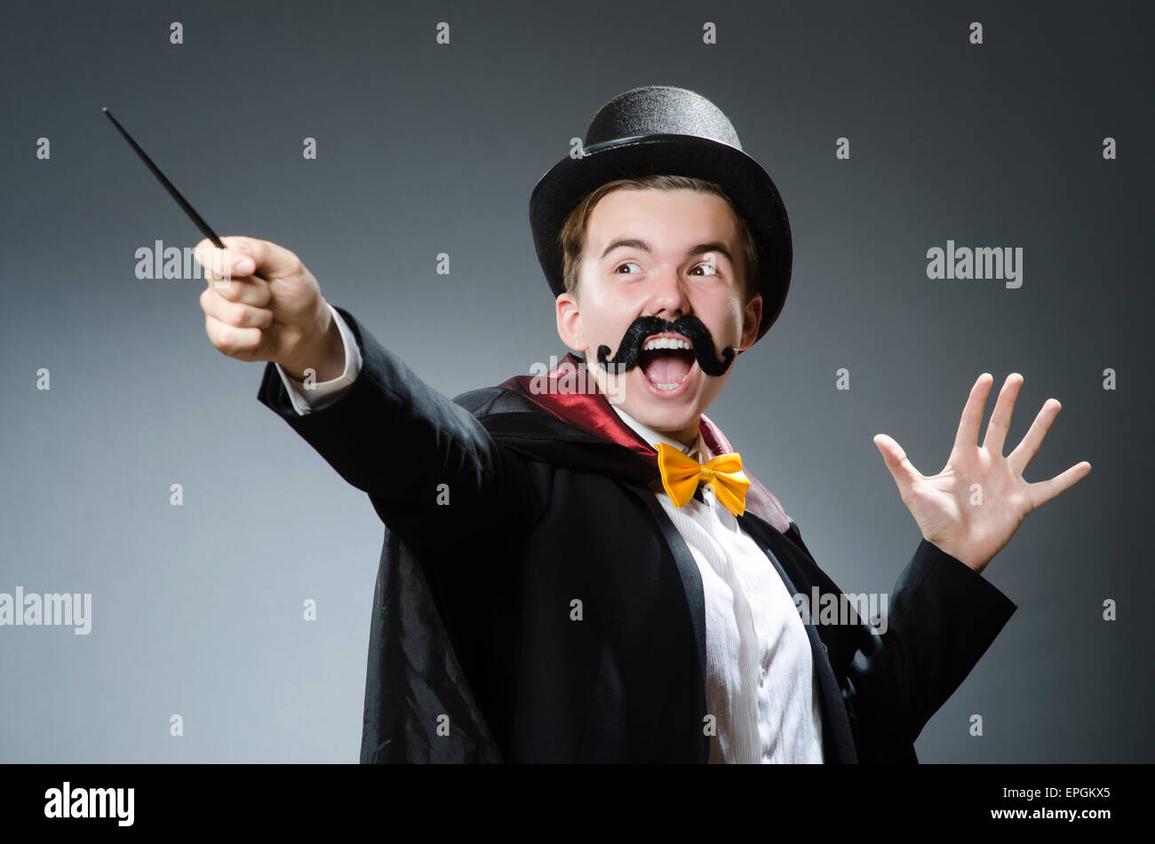 Funny magician with wand and hat Stock Photo - Alamy