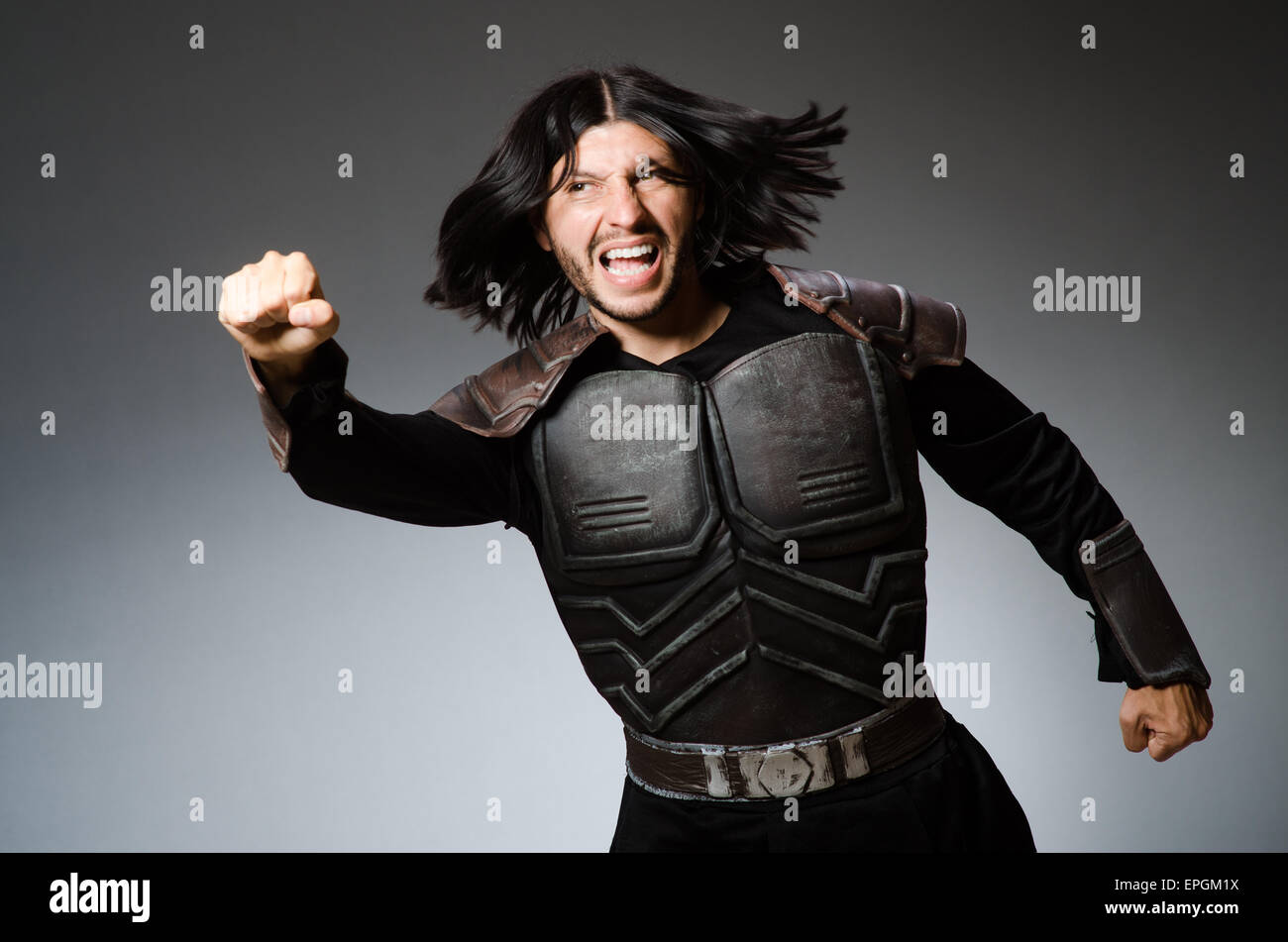 Angry warrior against dark background Stock Photo - Alamy