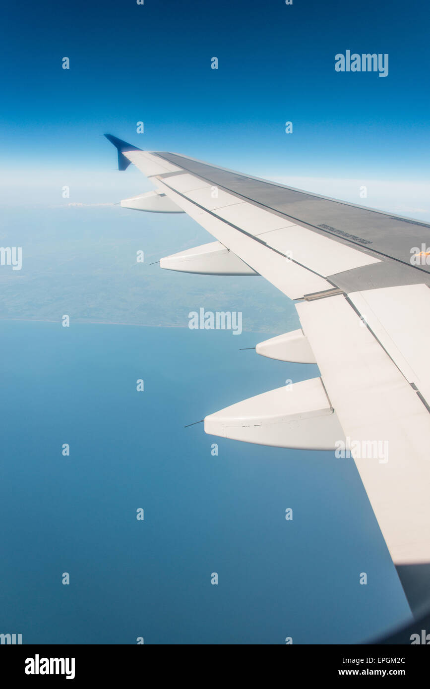 Airplane wing out of window Stock Photo - Alamy