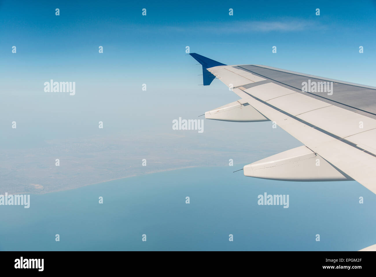 Airplane wing out of window Stock Photo - Alamy